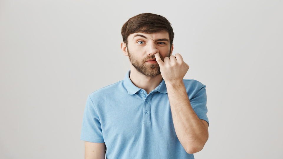 Portrait of funny impolite caucasian man with beard, picking nose with ...